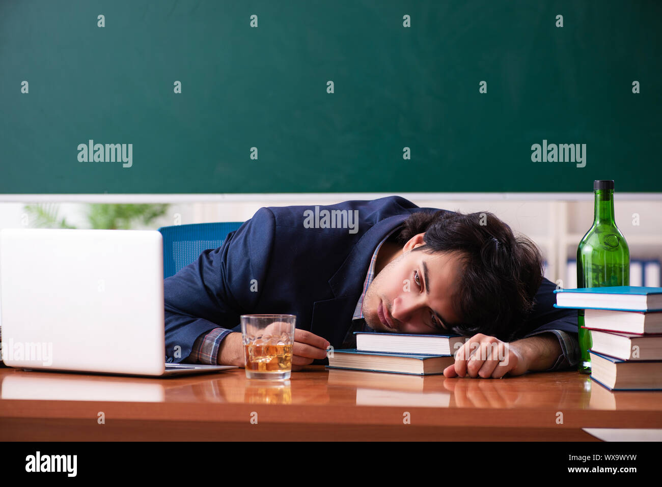 Male teacher drinking in the classroom Stock Photo - Alamy
