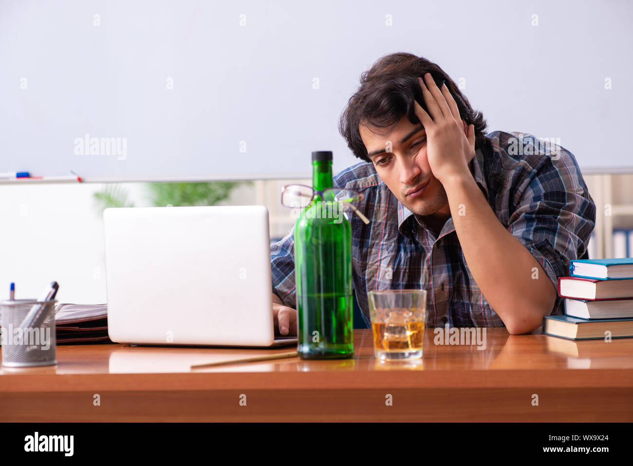 Male teacher drinking in the classroom Stock Photo - Alamy
