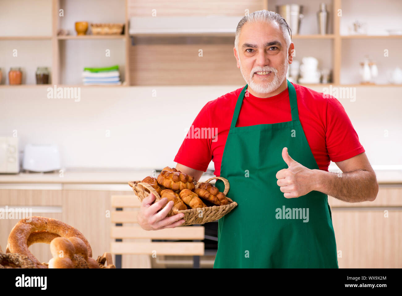Old male baker working in the kitchen Stock Photo - Alamy