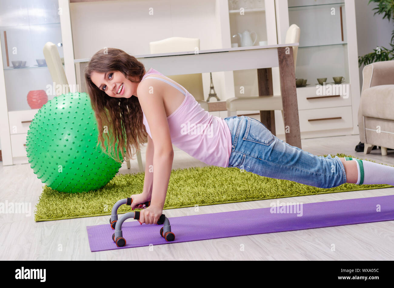Young beautiful woman doing exercises at home Stock Photo - Alamy