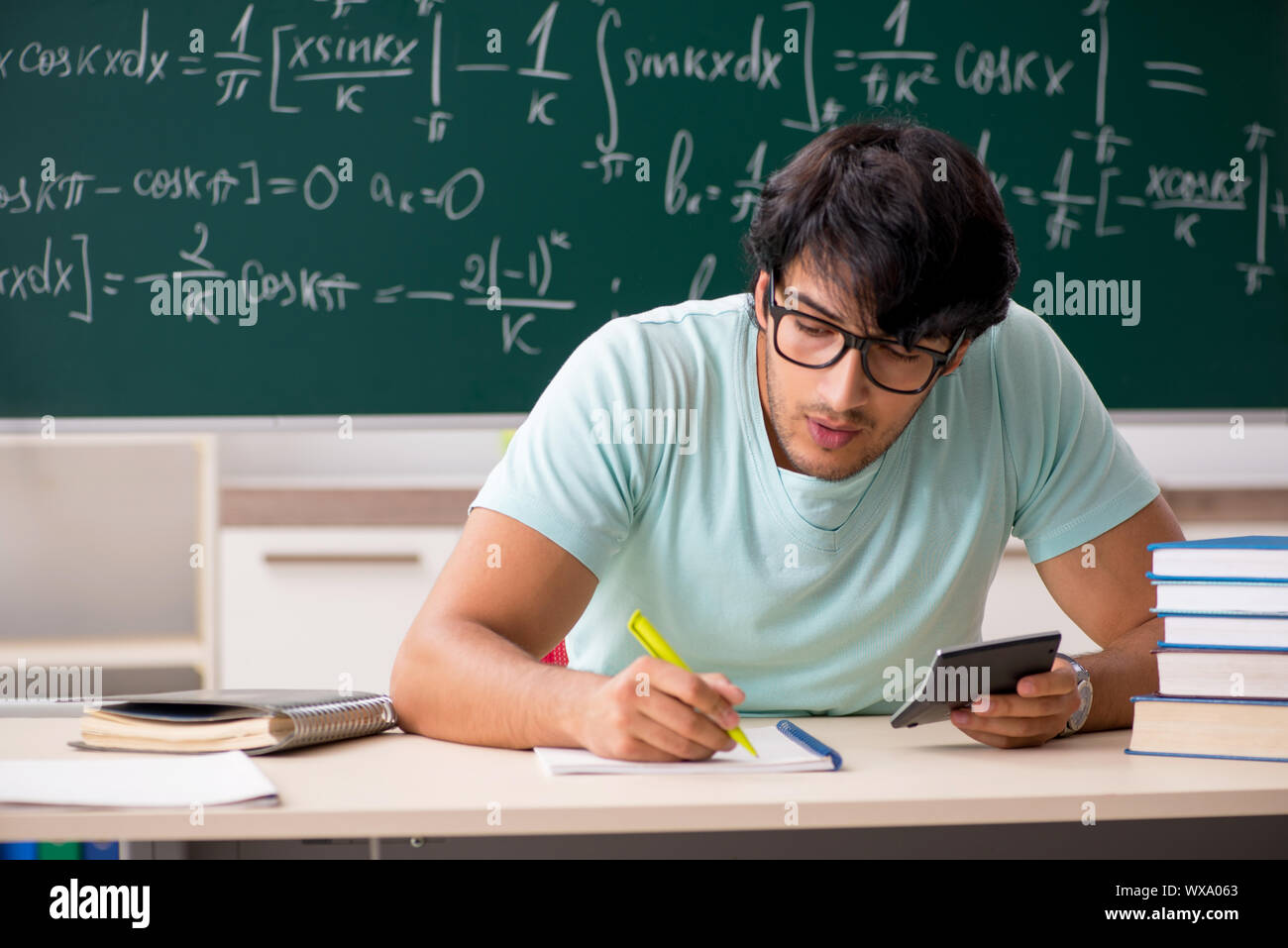 Young male student mathematician in front of chalkboard Stock Photo - Alamy