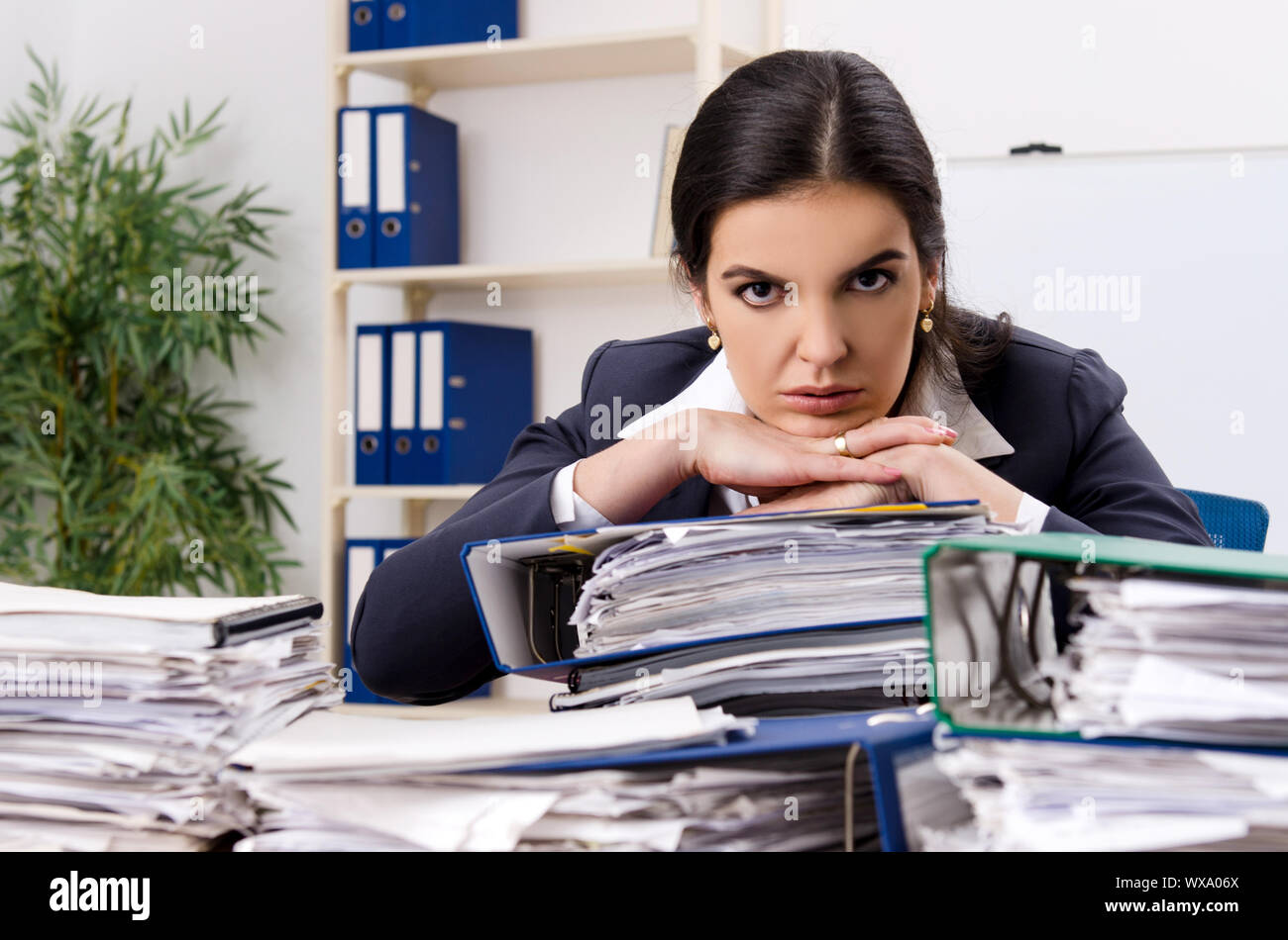 Female employee unhappy with excessive work Stock Photo - Alamy