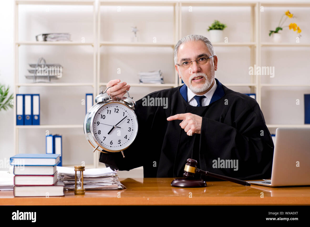 Aged lawyer working in the courthouse Stock Photo - Alamy