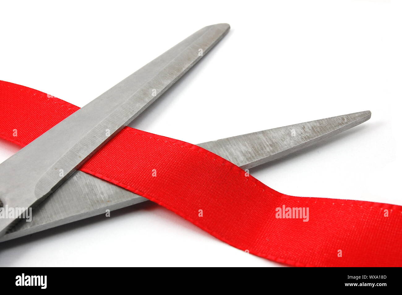 scissors and red ribbon isolated on white showing a ceremonial opening ...