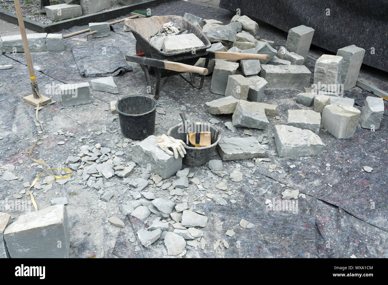 cutting and chopping stones for building a natural rock and stone wall ...