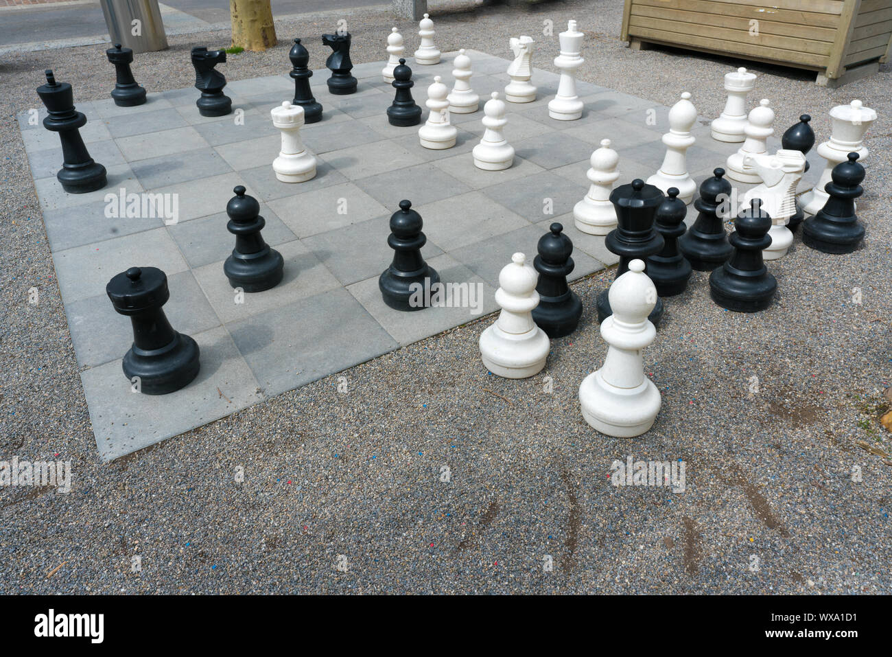 close up of a giant chess set in a town square ready to be played with ...