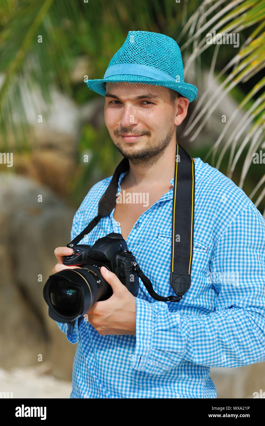 Man on a beach with camera Stock Photo - Alamy