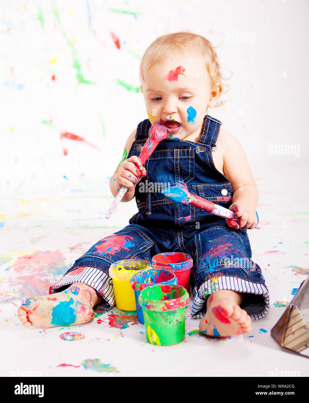 cute little baby painting and splatter with colours creativity on white ...