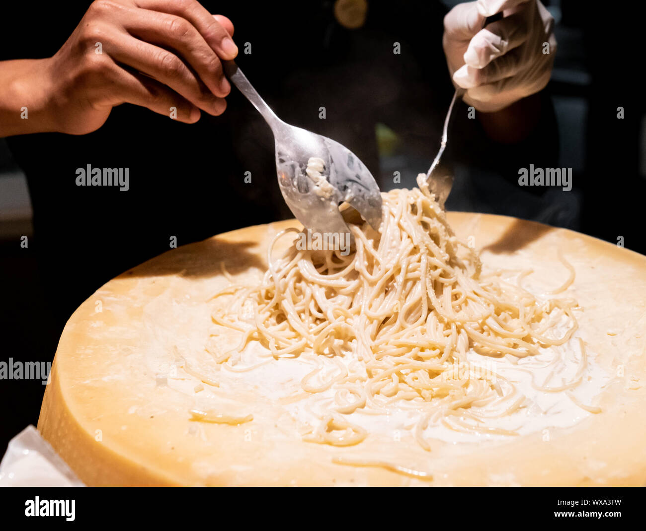 Pasta cooking in cheese bowl Stock Photo - Alamy