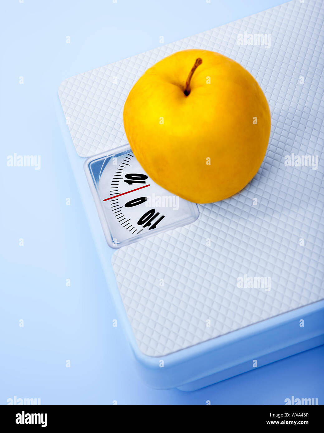 Apple on scale, body weight watching, conceptual image of dieting ...