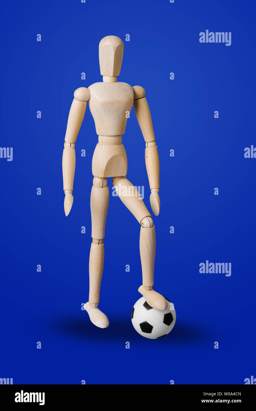 Football wooden toy figure on blue Stock Photo - Alamy