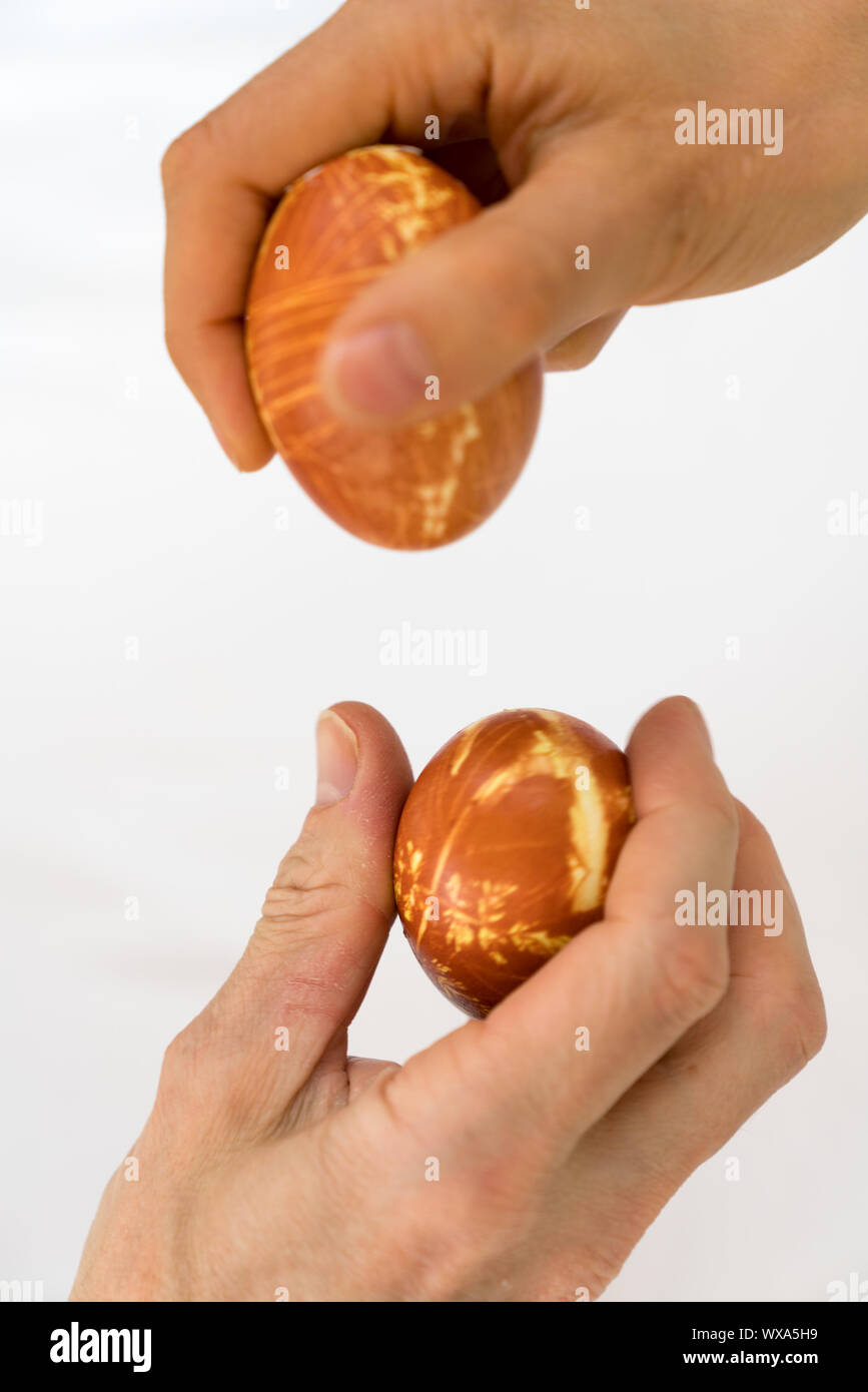 man and woman egg tapping at Easter with naturally colored eggs Stock ...