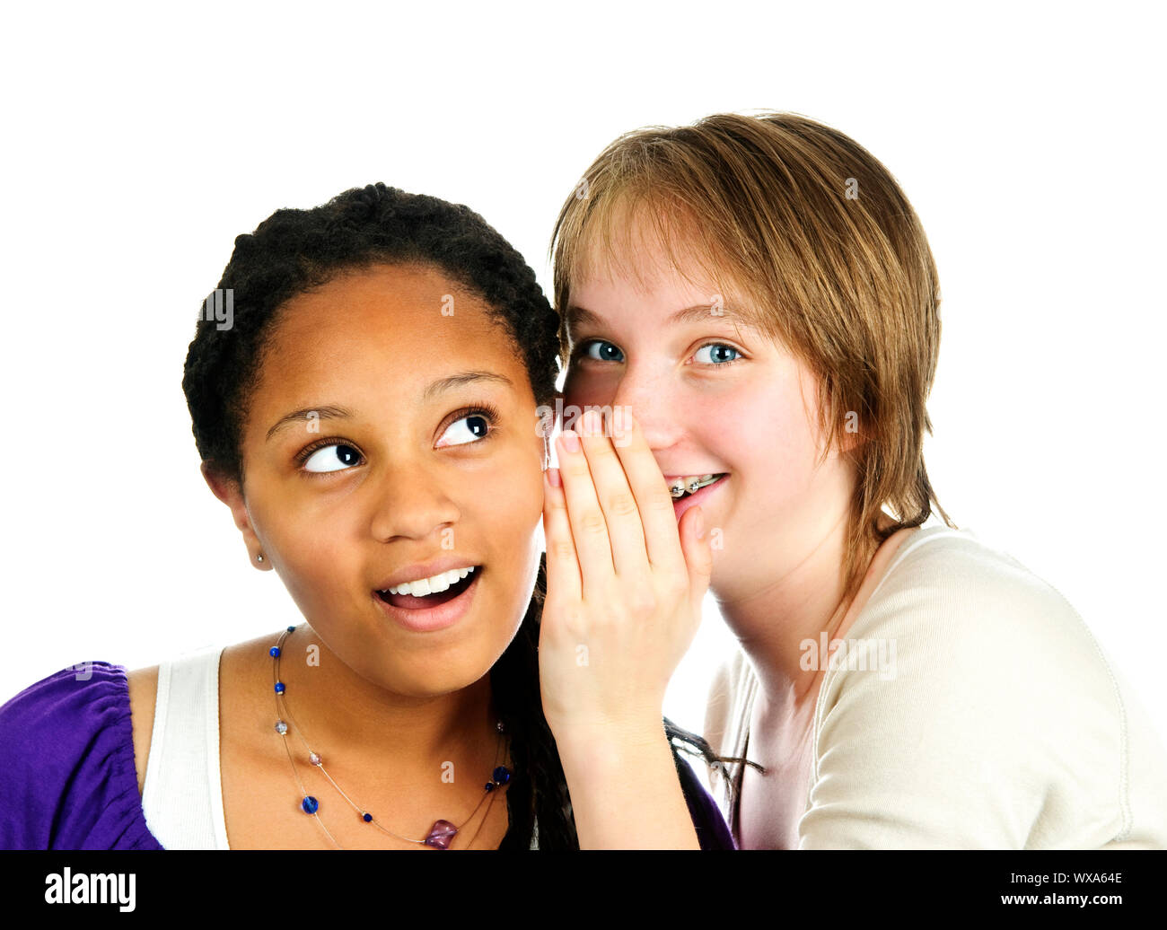 Isolated portrait of two diverse teenage girl friends whispering Stock ...