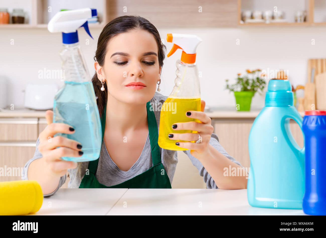 Young female contractor doing housework Stock Photo - Alamy