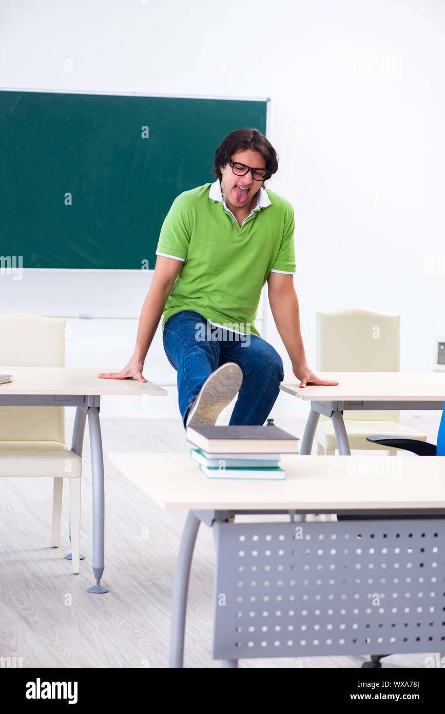Young student doing physical exercises in the classroom Stock Photo - Alamy
