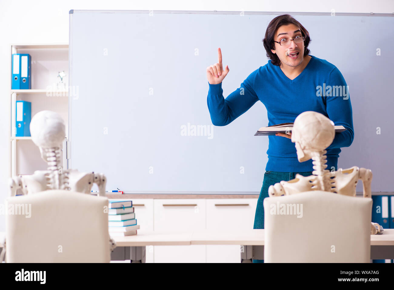 Male teacher and skeleton student in the classroom Stock Photo - Alamy
