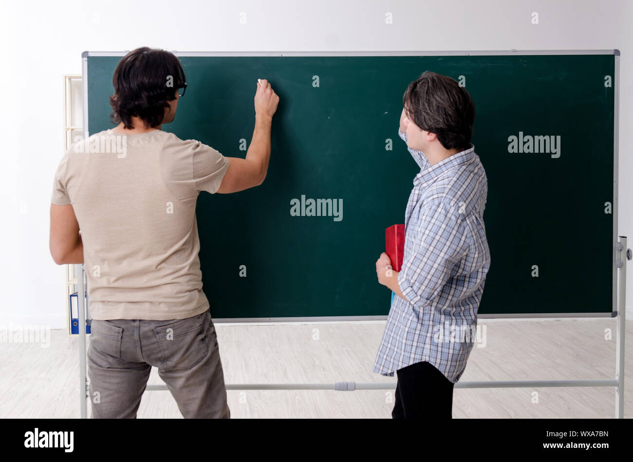 Two male students in the classroom Stock Photo - Alamy