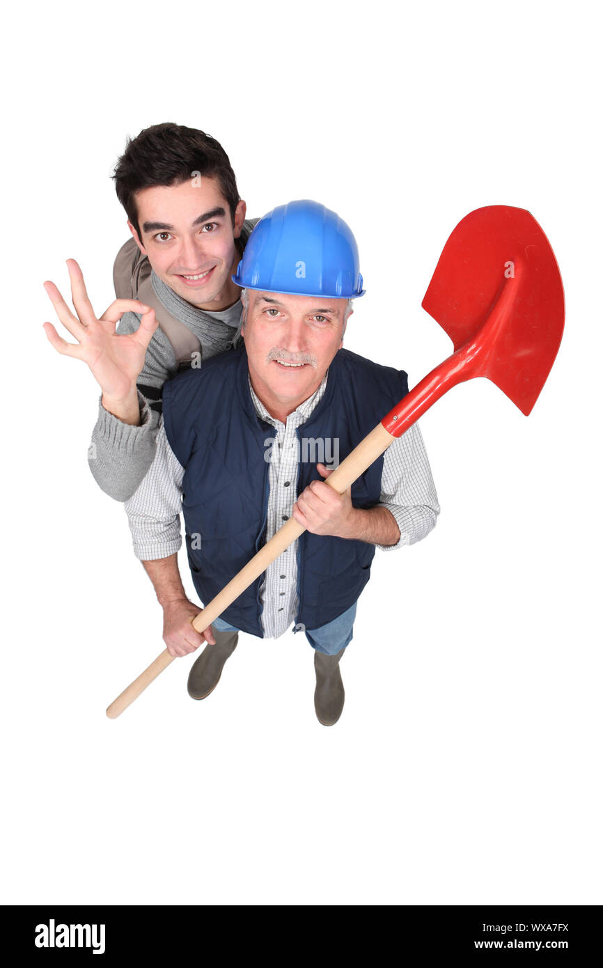 Builder stood with young apprentice Stock Photo - Alamy
