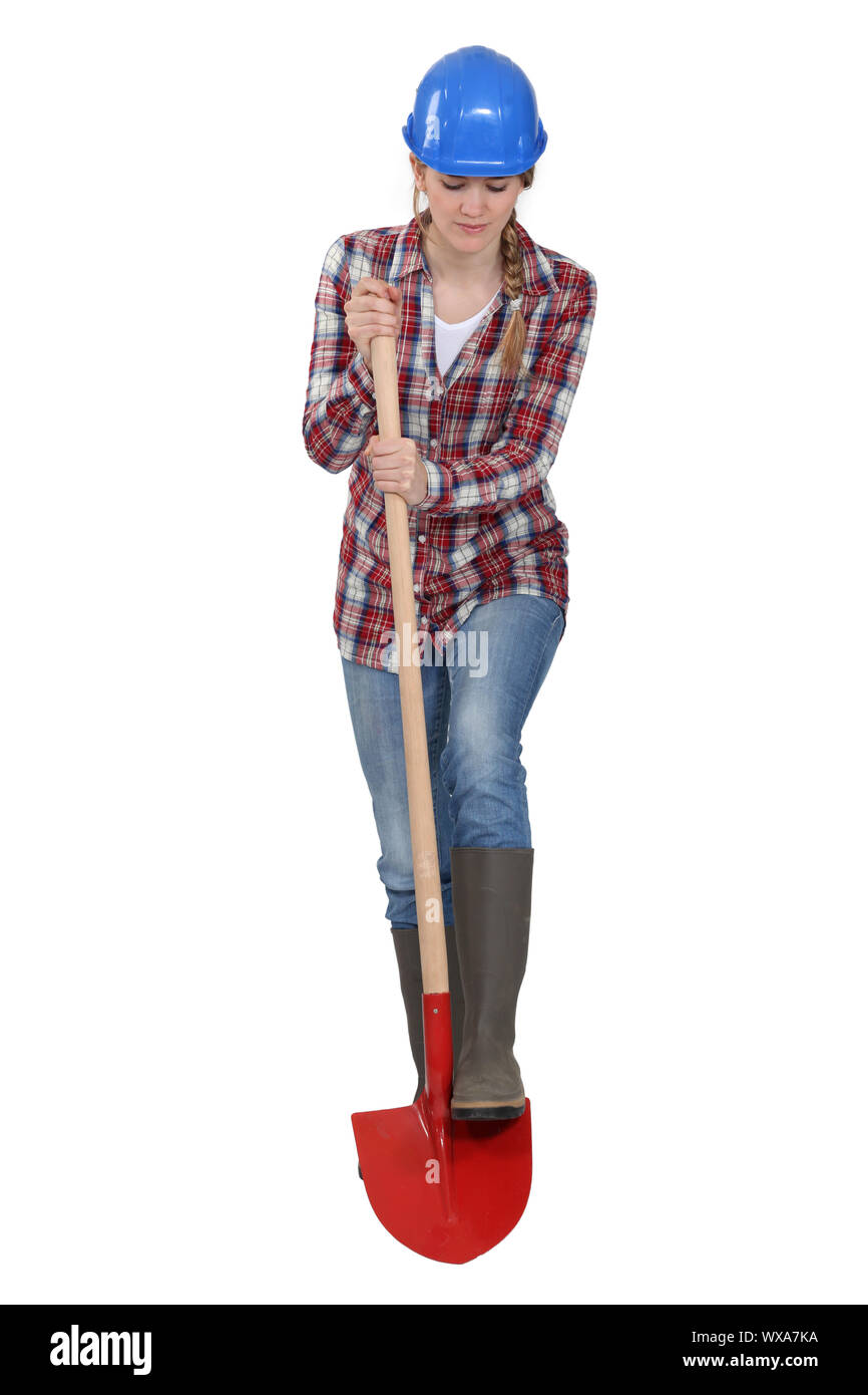Female laborer digging with shovel Stock Photo - Alamy