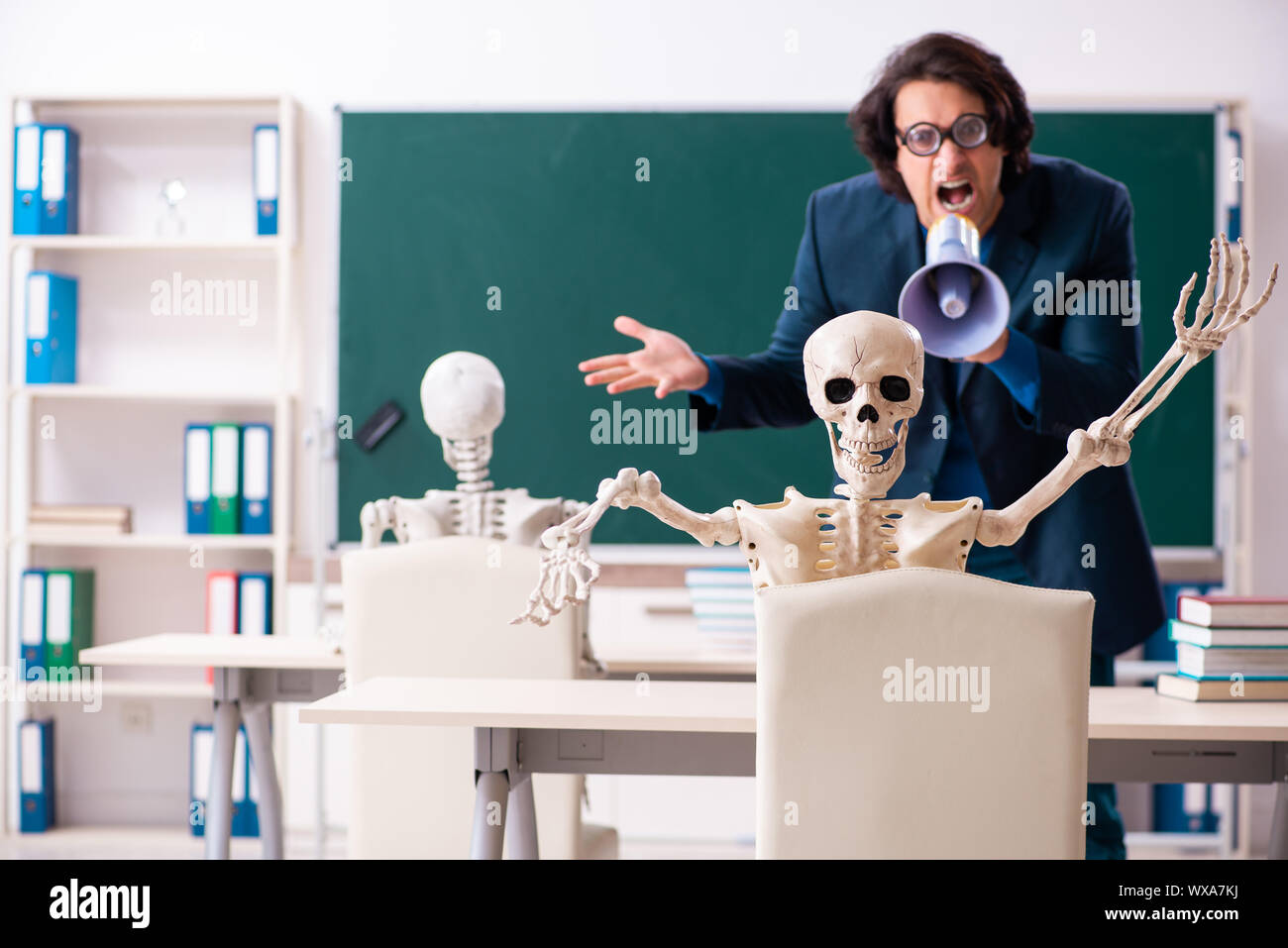 Male teacher and skeleton student in the classroom Stock Photo - Alamy