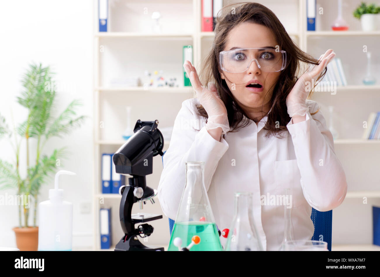 Funny female chemist working in the lab Stock Photo - Alamy