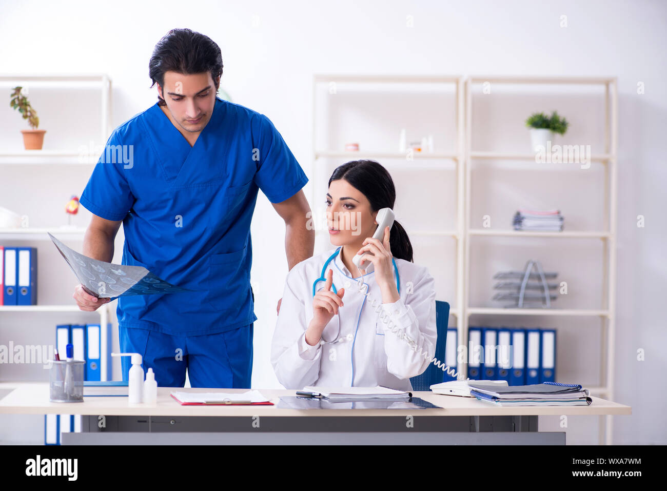 Two young doctors working in the clinic Stock Photo - Alamy