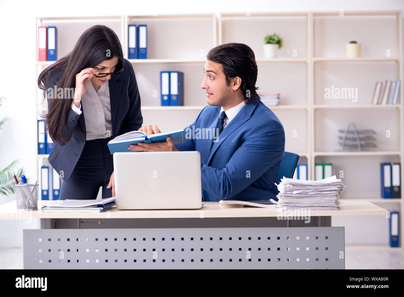 Two employees working in the office Stock Photo - Alamy