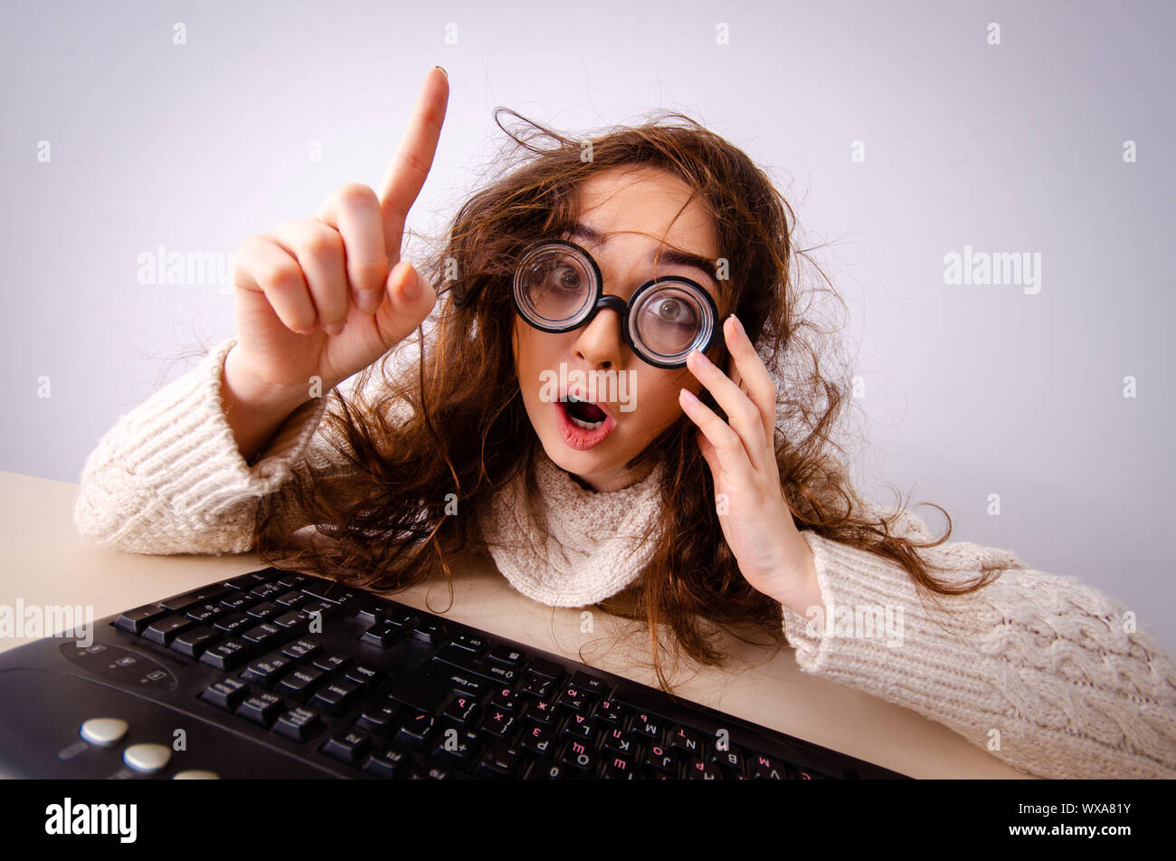Funny nerd girl working on computer Stock Photo - Alamy