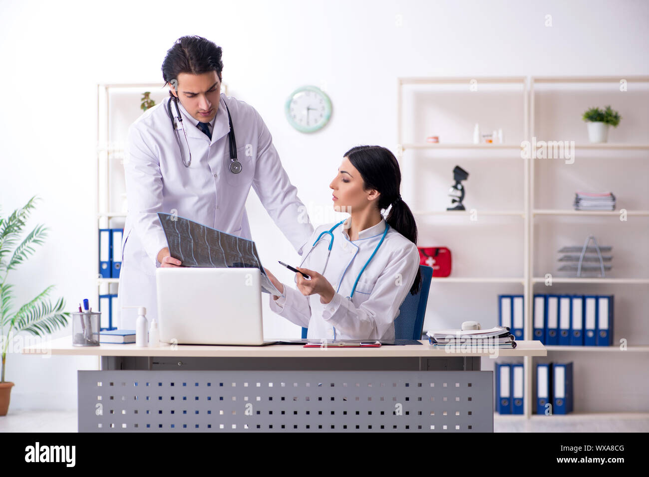 Two young doctors working in the clinic Stock Photo - Alamy