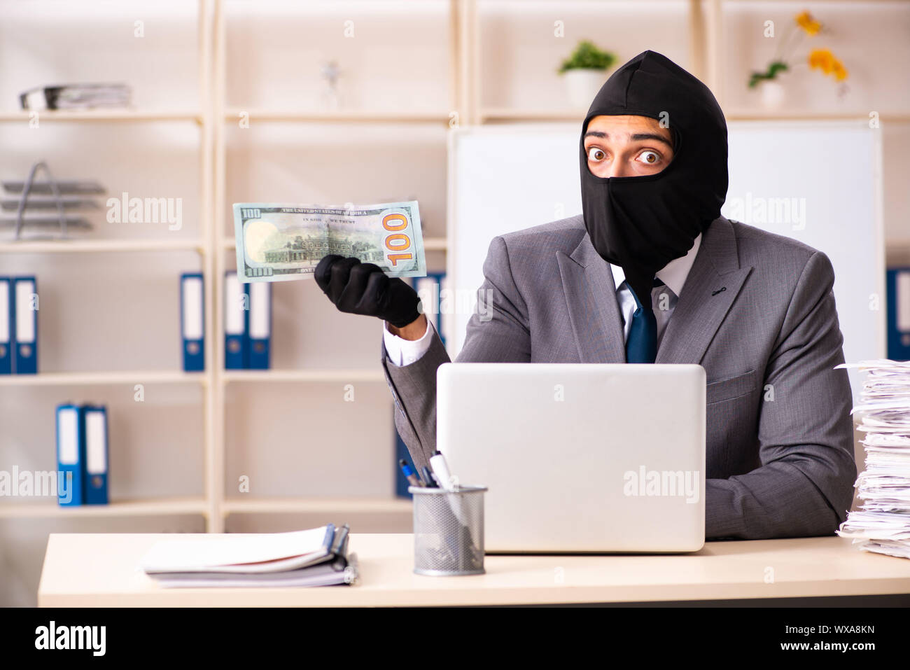 Male gangster stealing information from the office Stock Photo - Alamy