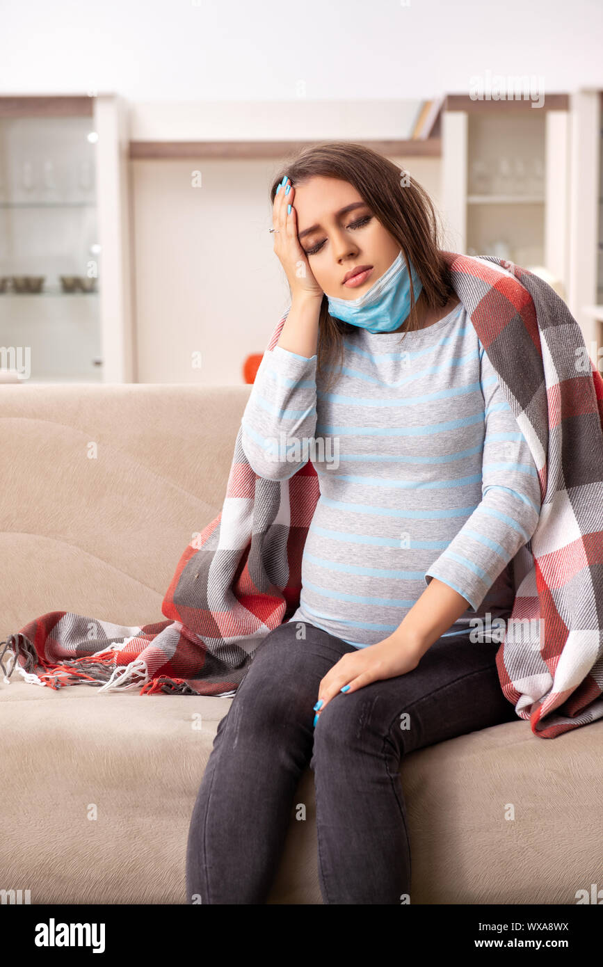 Sick pregnant woman suffering at home Stock Photo - Alamy