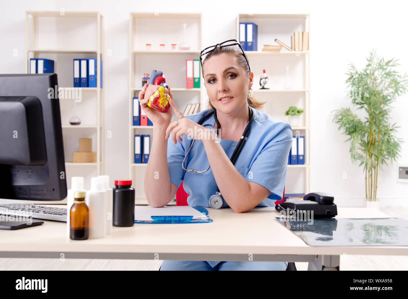 Female doctor cardiologist working in the clinic Stock Photo - Alamy