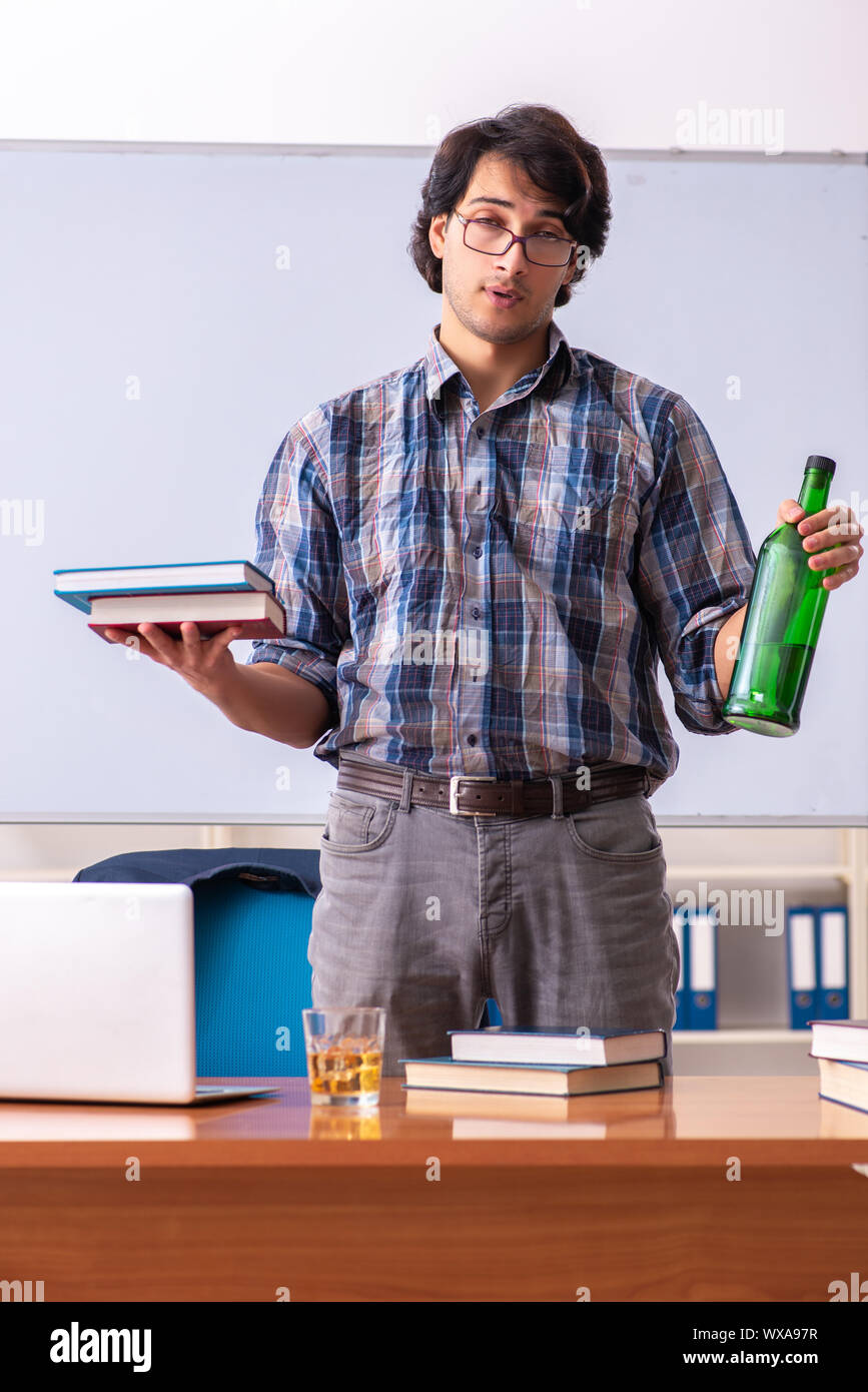 Male teacher drinking in the classroom Stock Photo - Alamy