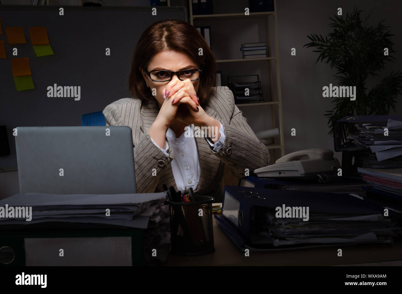 Female employee suffering from excessive work Stock Photo - Alamy