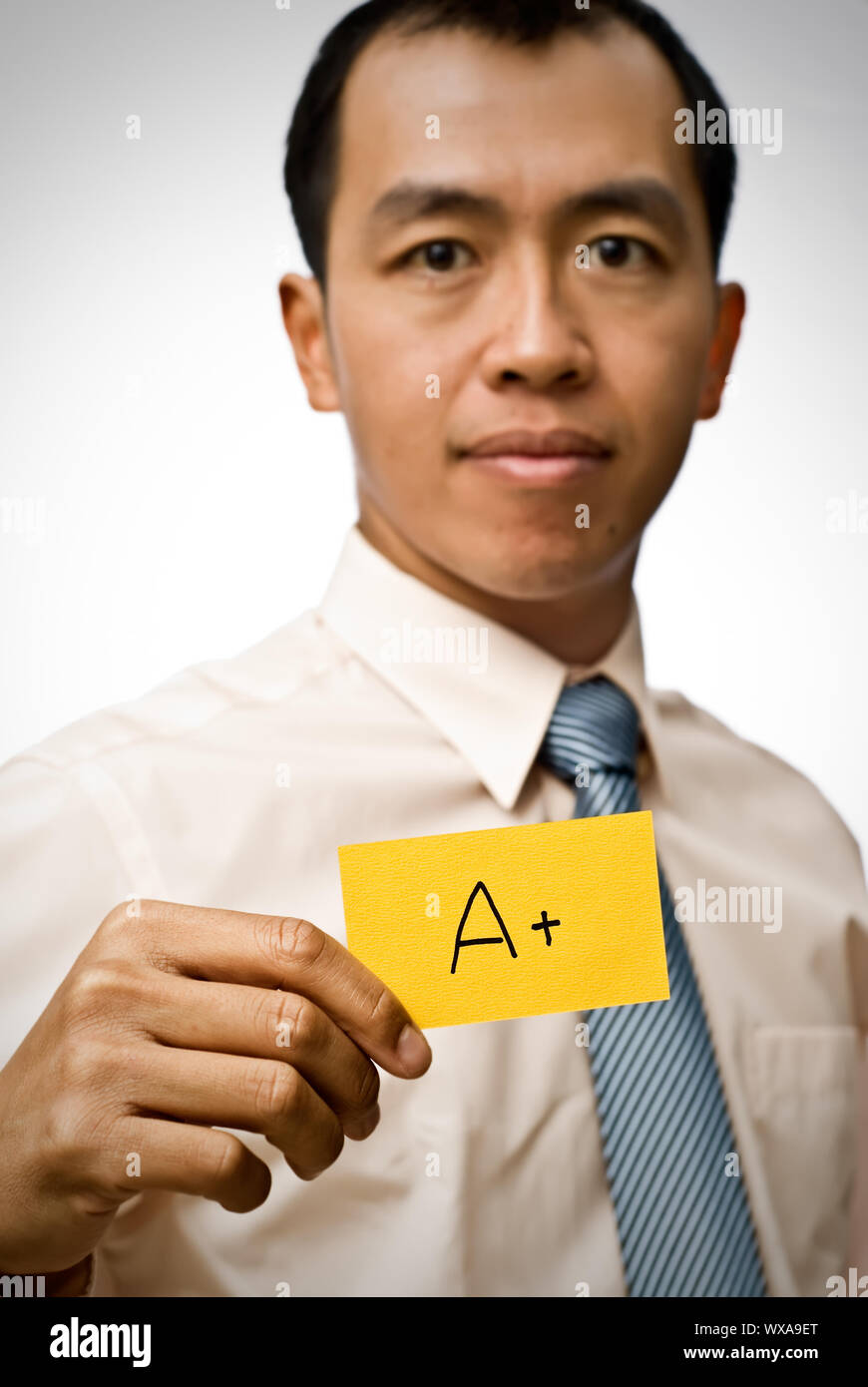 A plus sign on yellow card holding by businessman of Asian Stock Photo ...