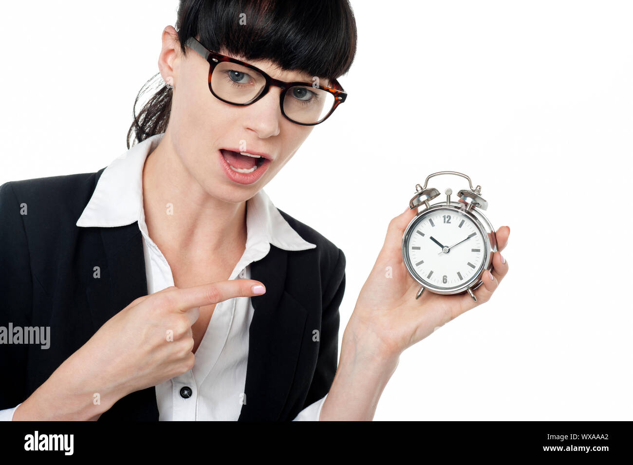Amazed female executive pointing at time. You are late for the meeting ...