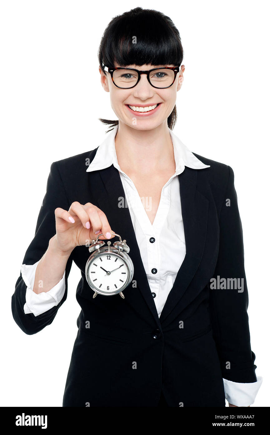 Smiling young lady showing an old fashioned time piece to the camera ...