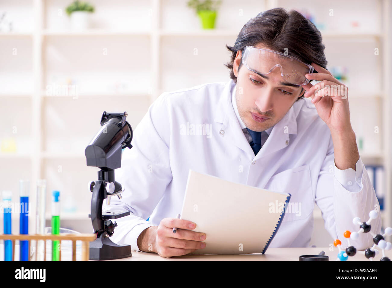Young male scientist working in the lab Stock Photo - Alamy