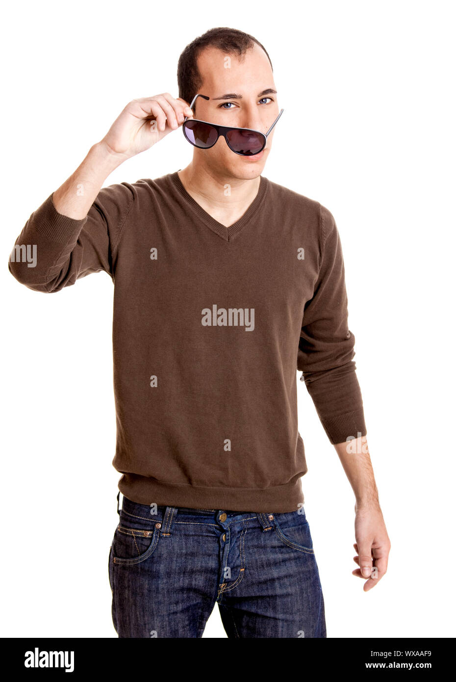 Portrait of a confident young man taking off the sunglasses, isolated ...
