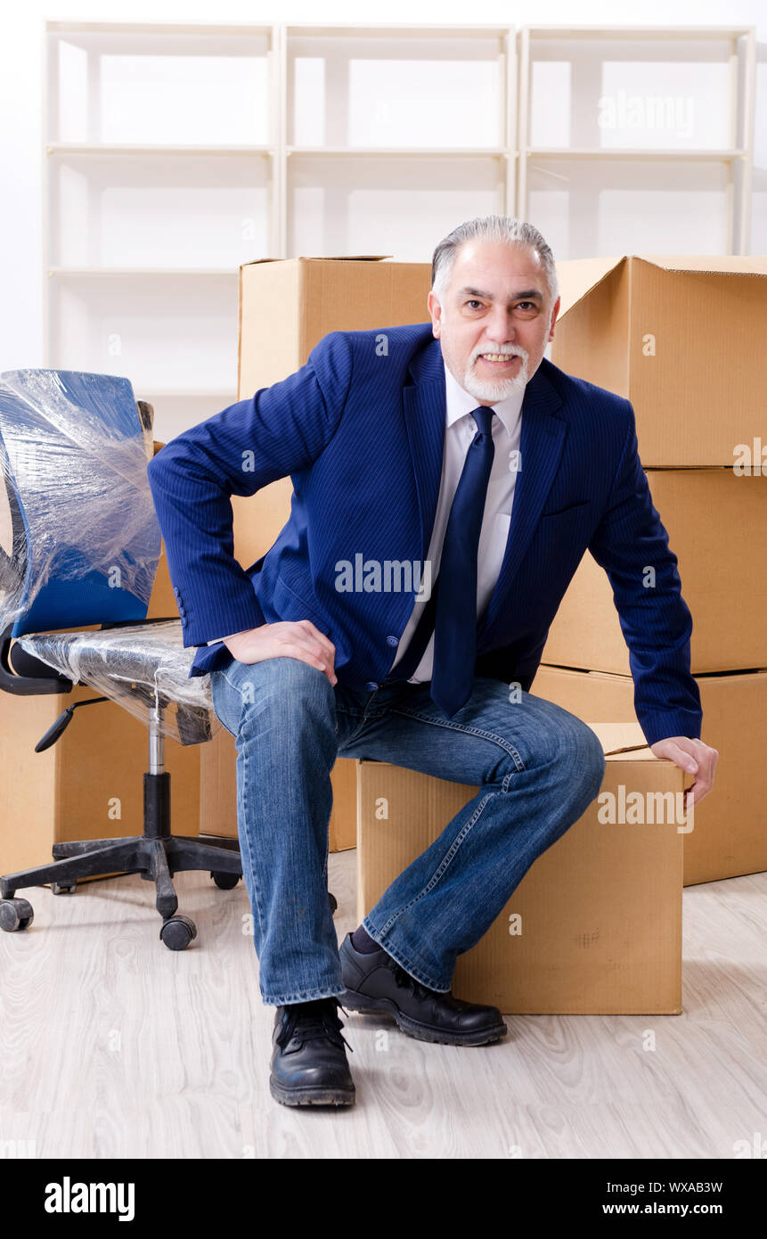 Aged businessman moving to new workplace Stock Photo - Alamy