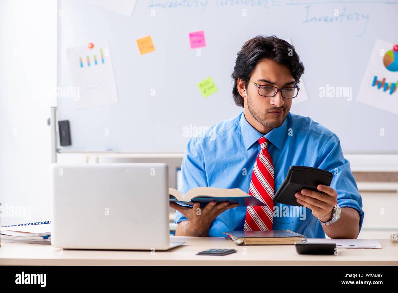 Young male financial manager working in the office Stock Photo - Alamy