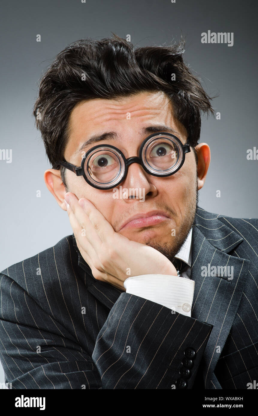 Funny nerd businessman in dark studio Stock Photo - Alamy