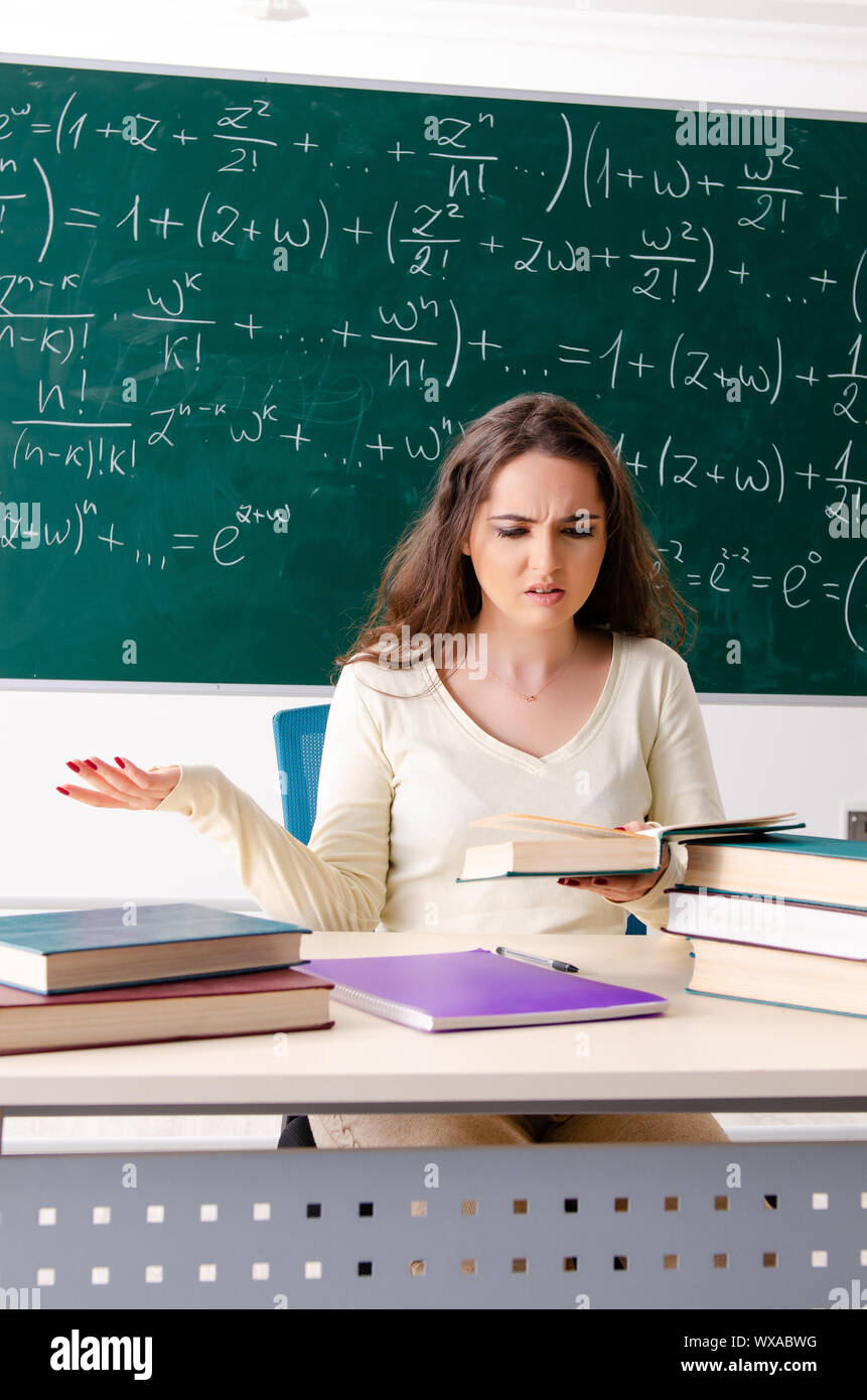 Young female math teacher in front of chalkboard Stock Photo - Alamy