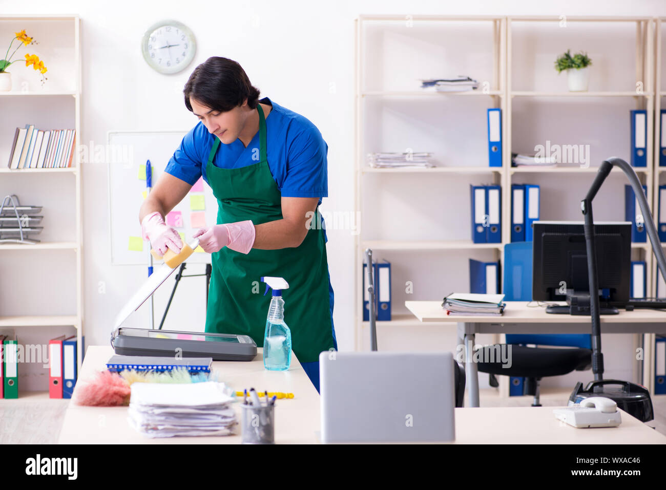 Male handsome professional cleaner working in the office Stock Photo ...