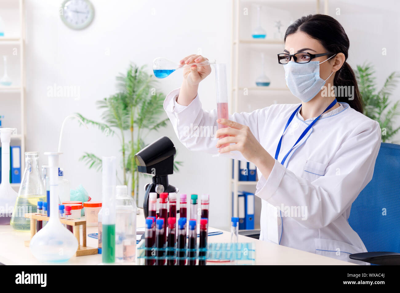 Female scientist mixing chemical solution hi-res stock photography and ...
