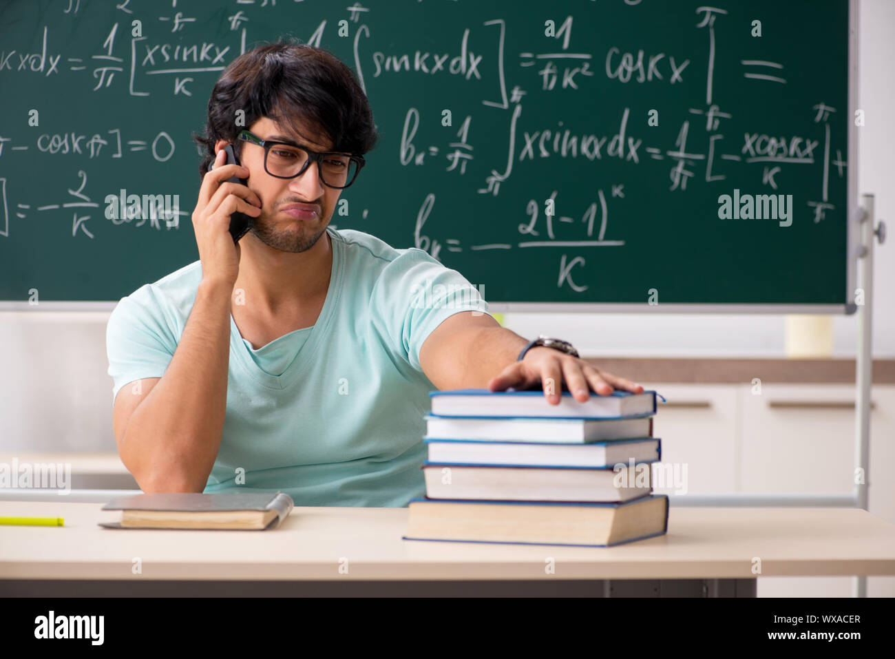 Young male student mathematician in front of chalkboard Stock Photo - Alamy