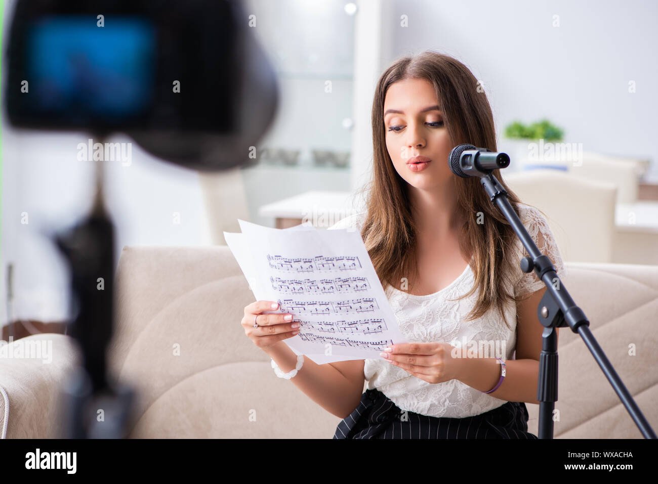 Female beautiful blogger singing at home Stock Photo - Alamy
