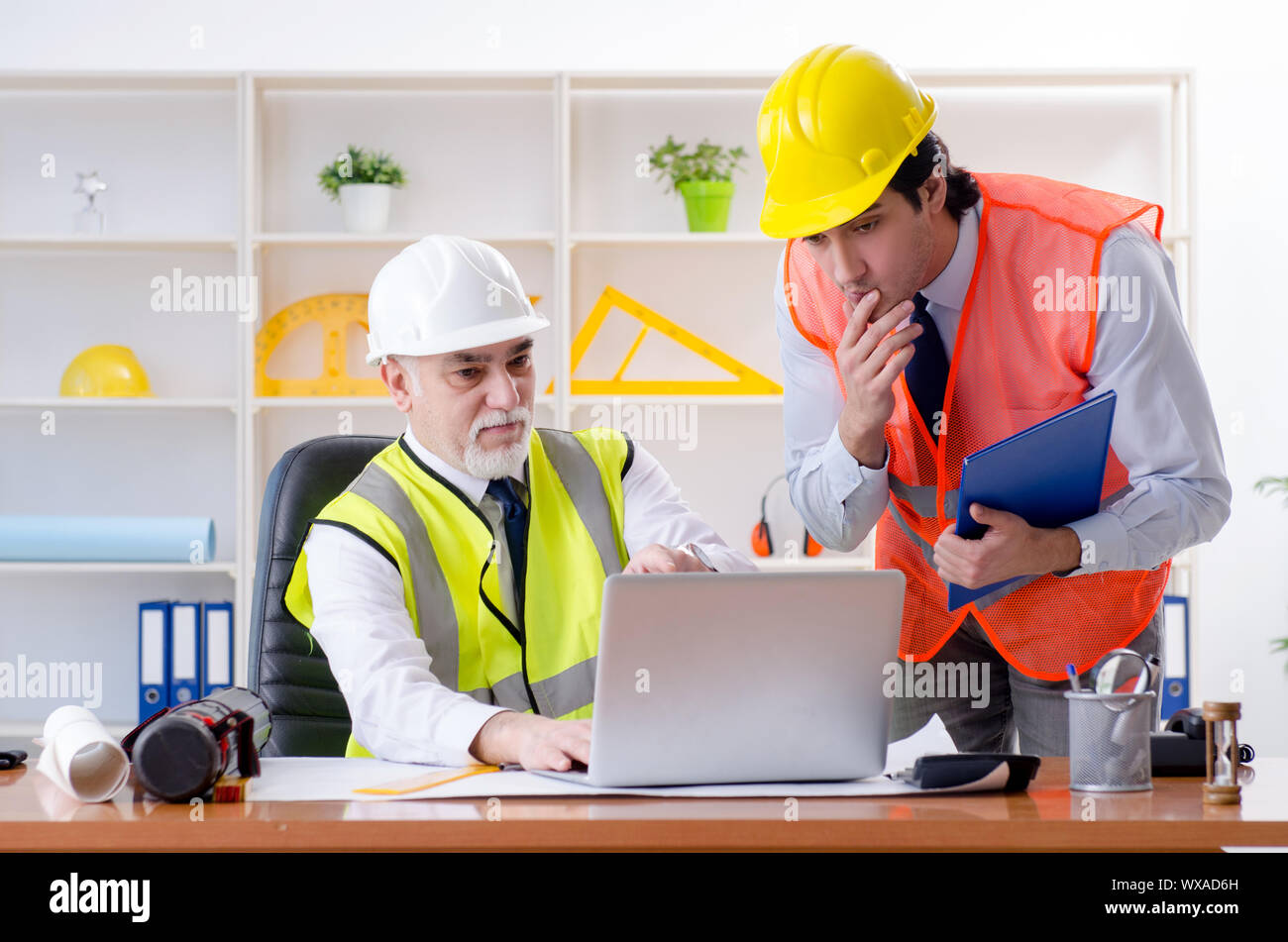 Two engineers colleagues working under project Stock Photo - Alamy