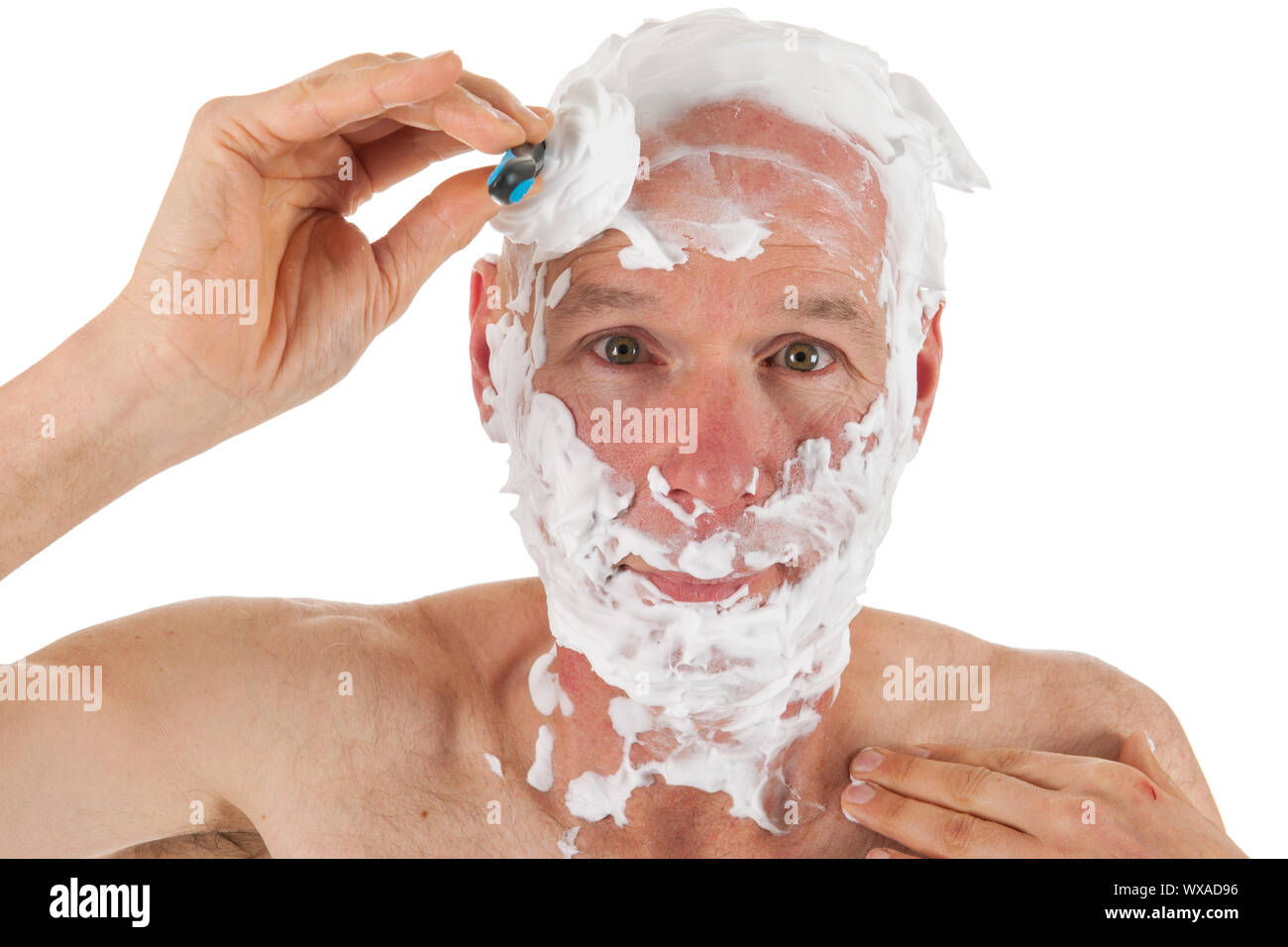 Shaving bald man with razor and foam is shaving his head Stock Photo ...
