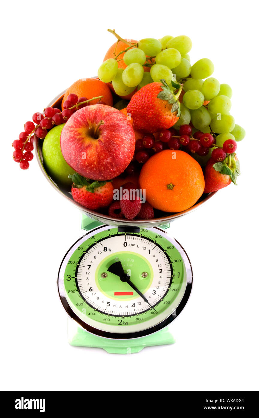 Kitchen scale with a diversity fruit for diet Stock Photo - Alamy